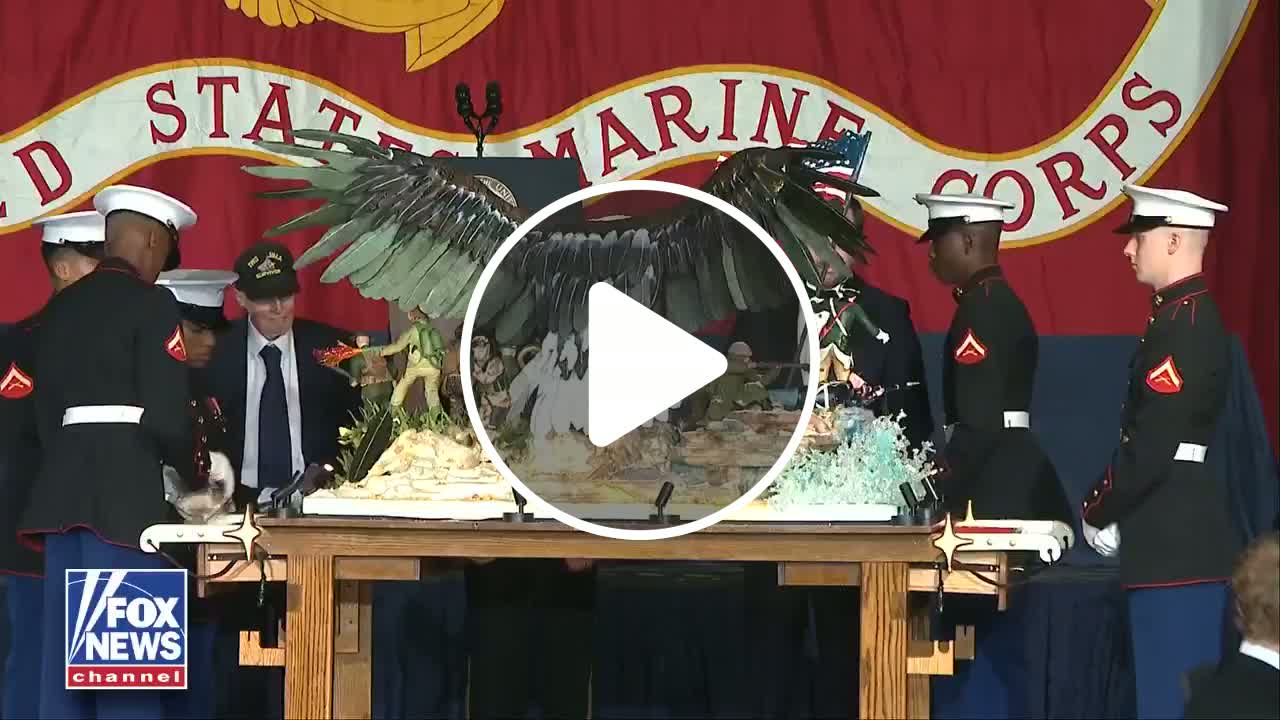 VP Vance presents a piece of cake to the oldest Marine in attendance at ...
