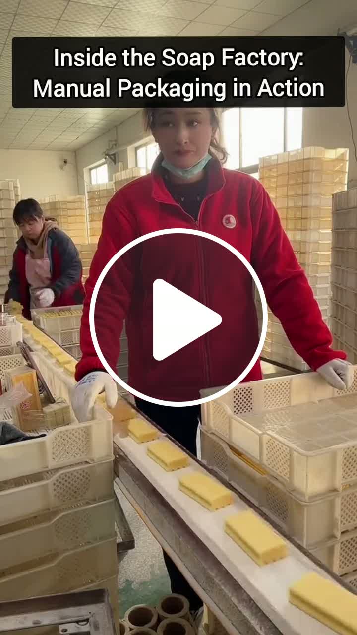 A Manual Packaging Process Is Underway In A Soap Factory, Where Workers ...