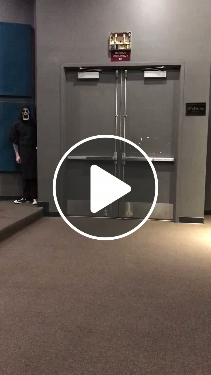 Professor is dressed in a costume and waits to scare students coming to ...