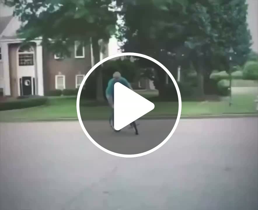 Grandpa casually teaching his grandson how to ride a bicycle when his ...