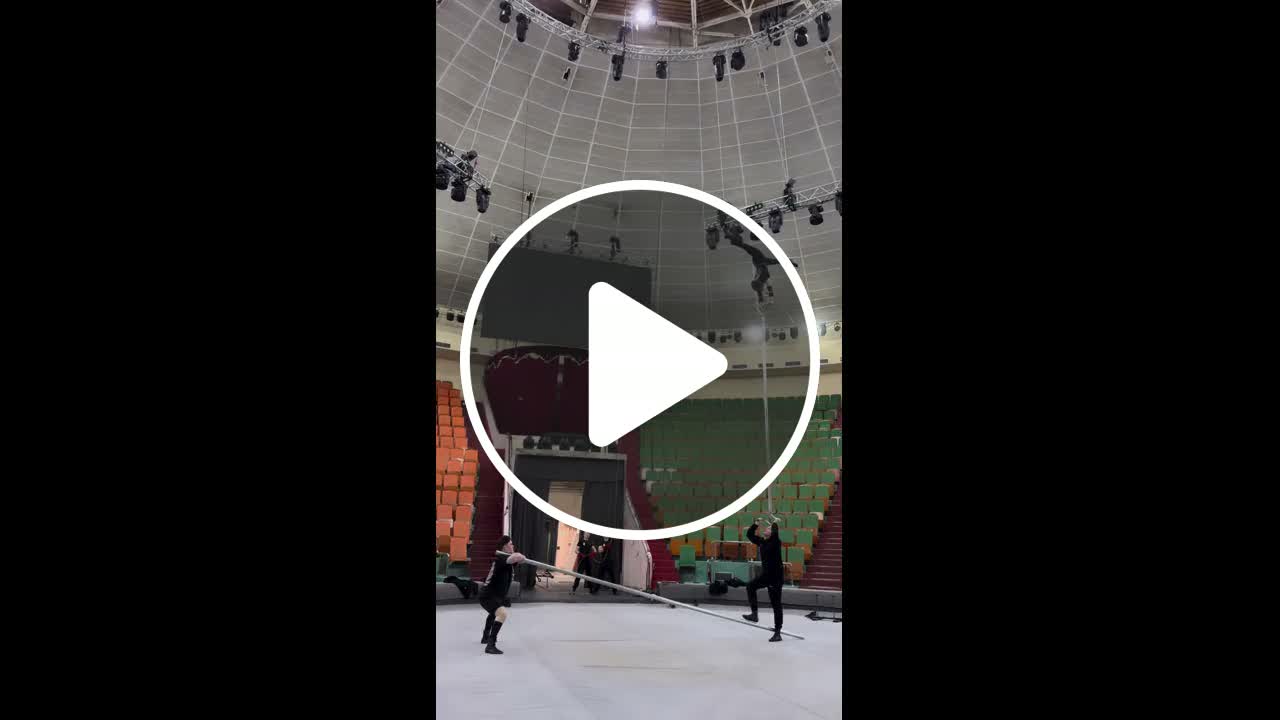 Daring Circus Acrobats Balancing on a Towering Pole - NewsBreak