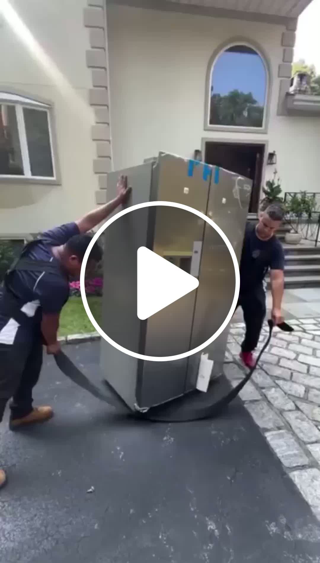Moving crew demonstrates how to lift a heavy appliance with ease ...