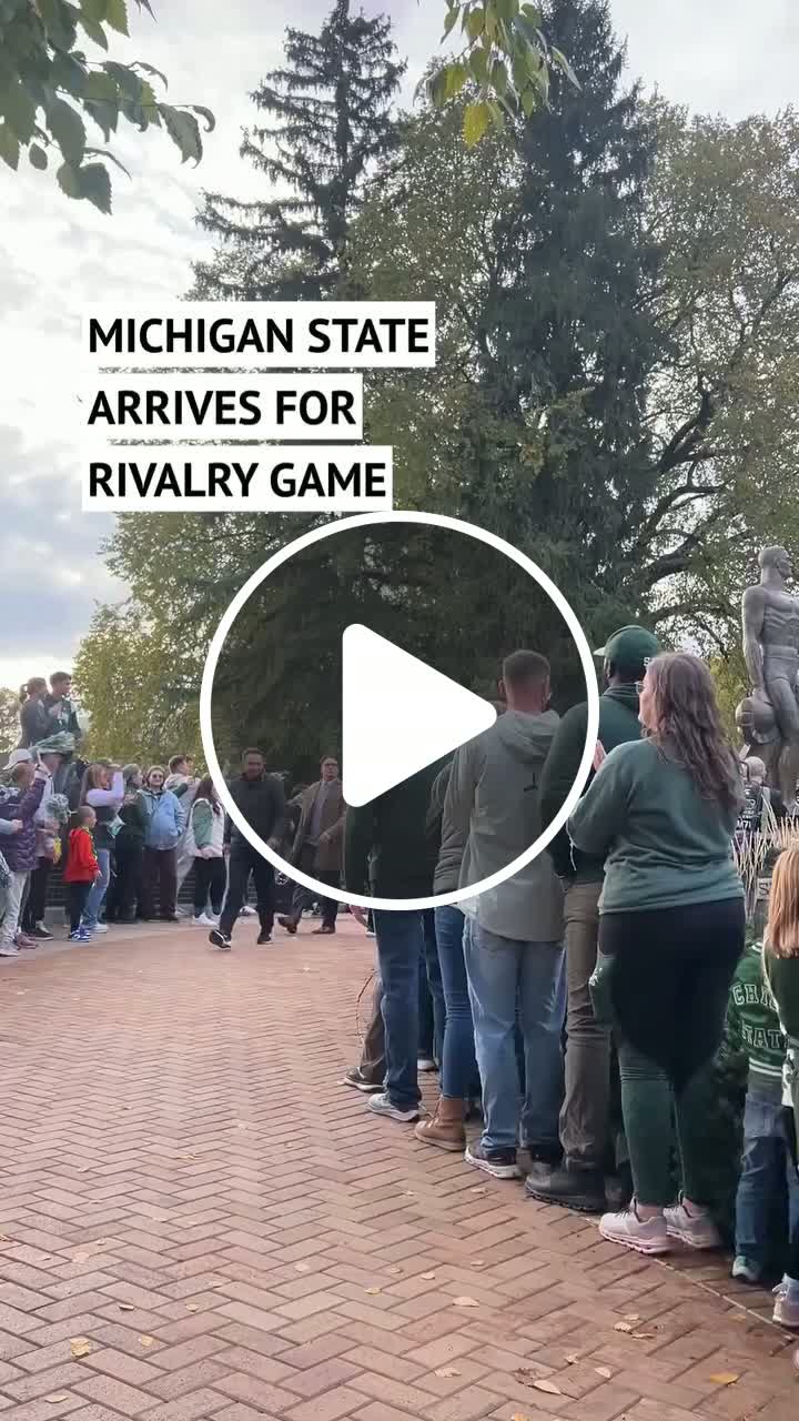 The Michigan State Spartans arrive at the Spartan Statue, led by head ...